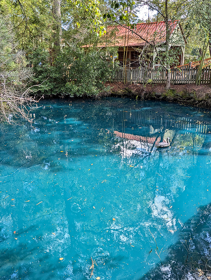 Not a mirage&mdash;that's an actual blue pond reflecting the wooden structures of Deadwood, adding unexpected serenity to your Wild West adventure.