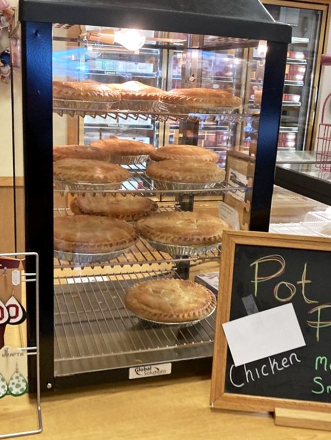 Pot pies waiting patiently behind glass, like savory celebrities at a meet-and-greet. Comfort food doesn't get more photogenic than this.