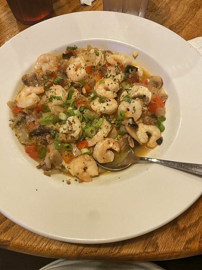 Shrimp and grits with a savory broth that ties everything together &ndash; the dish that convinces Northern visitors that grits were worth the trip south.