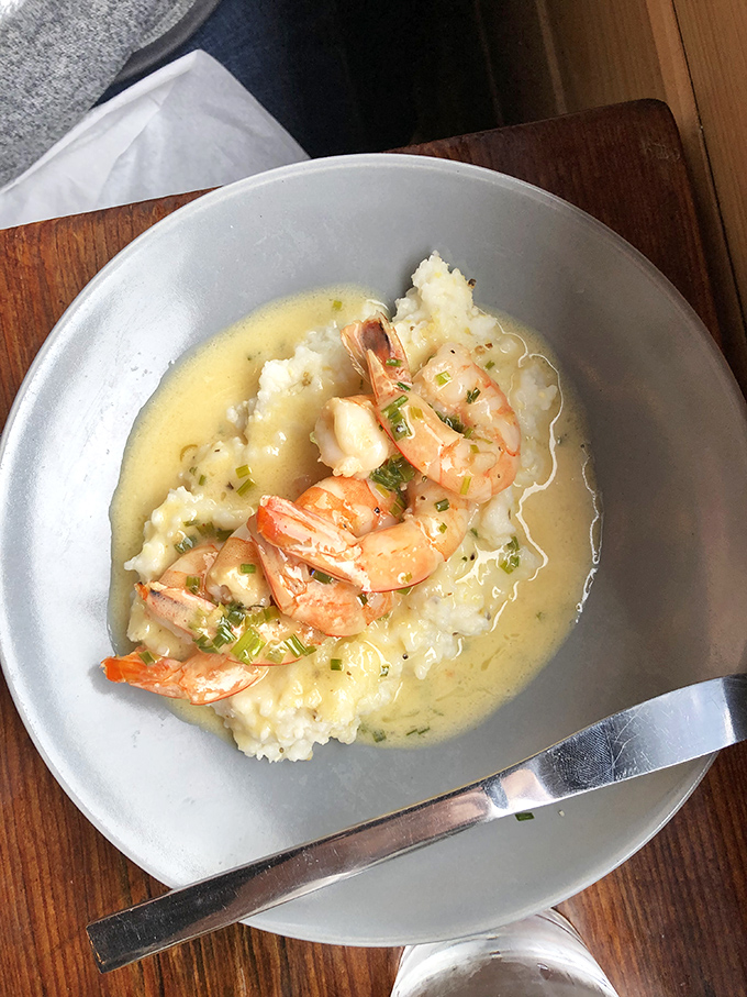 Shrimp and grits: a Southern classic elevated to art form. Those plump shrimp lounging in buttery sauce are living their best afterlife.