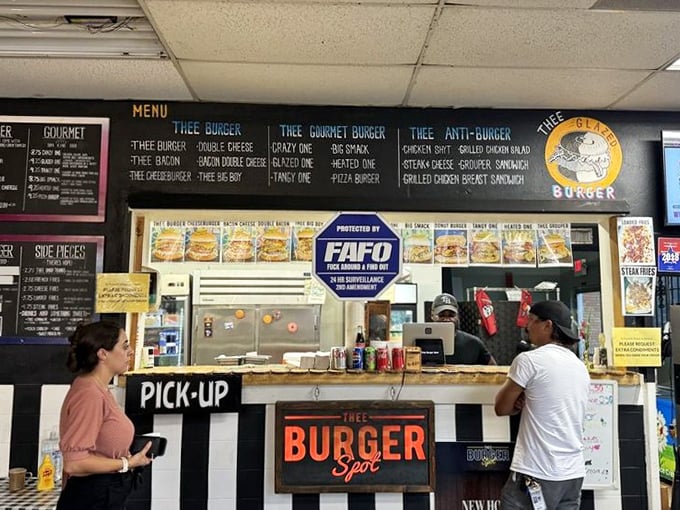 The pickup counter's black and white striped facade gives a referee vibe, as if officiating the serious sport of burger craftsmanship.