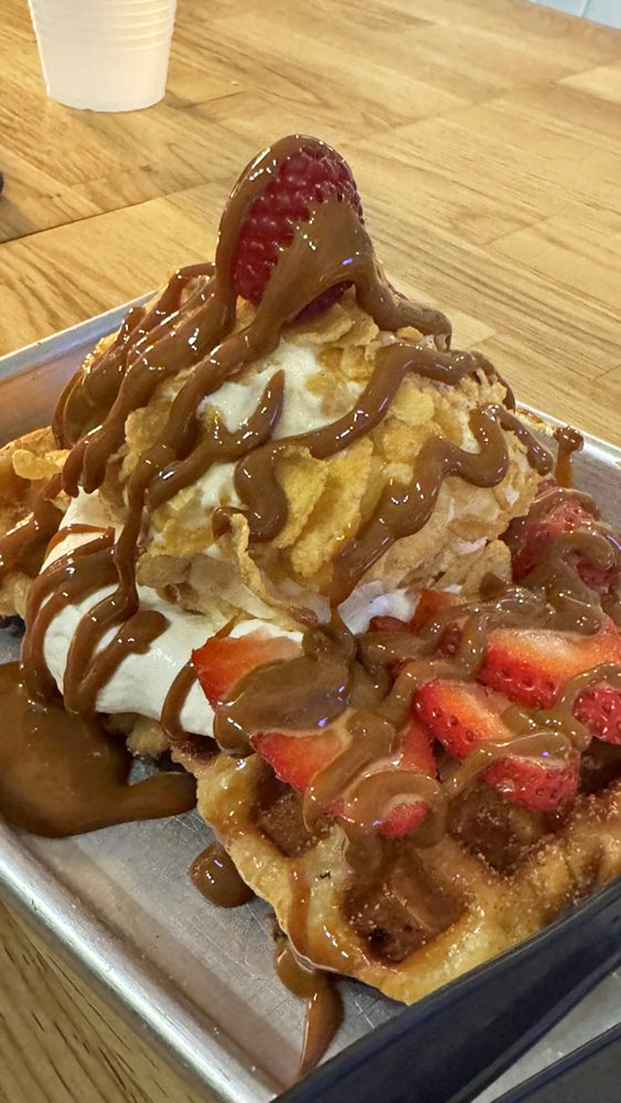 Chocolate drizzle cascading over berries and cream&mdash;this isn't just a waffle, it's a celebration on a plate. Your diet can wait.