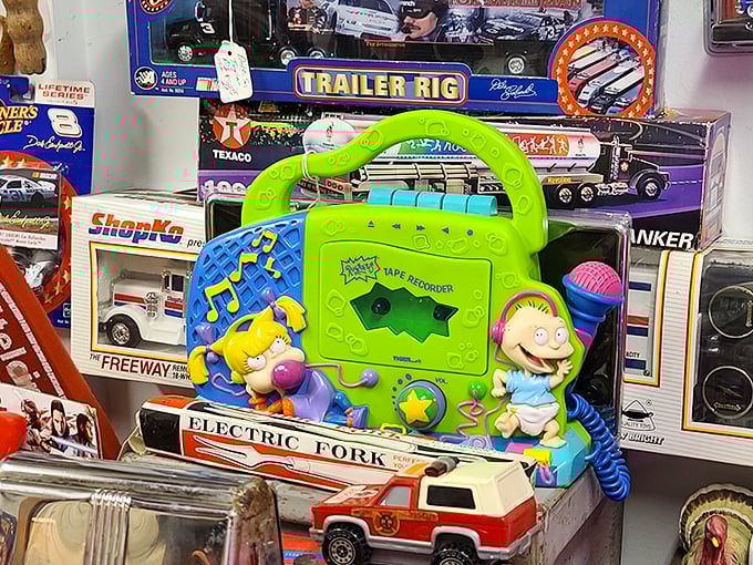 Rugrats tape player meets vintage toy trucks—childhood nostalgia spanning generations. The batteries may be dead, but the memories are fully charged.