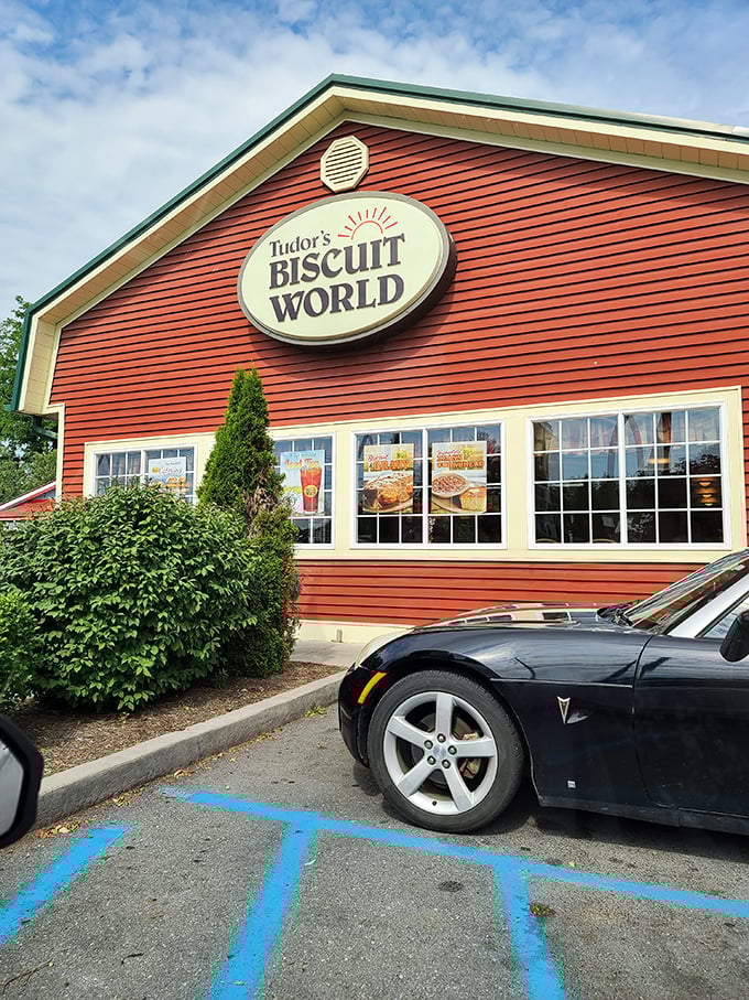 Tudor's Biscuit World's bright red exterior is like a breakfast lighthouse, guiding hungry travelers toward buttery, flaky salvation.