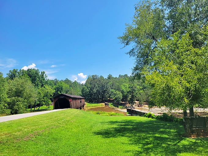 Summer's perfect equation: blue skies + green grass + rustic bridge = memories that outlast the season itself.