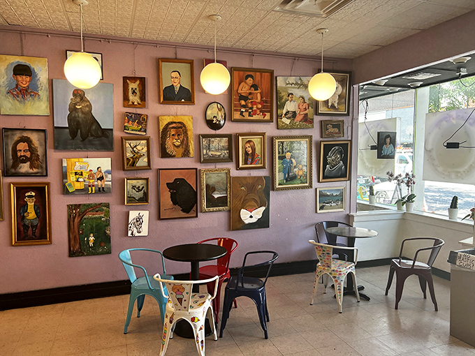 Where Renaissance portraiture meets modern metal chairs - a dining area that feels like eating dessert inside a quirky museum.