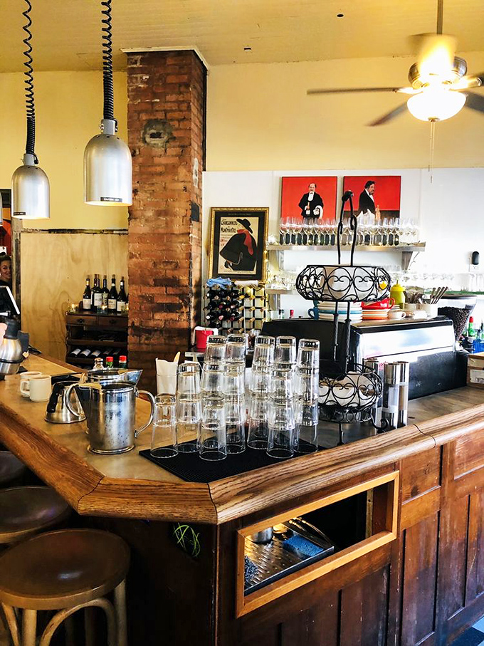 At this bar, wine bottles stand at attention like soldiers guarding the sacred traditions of French hospitality.