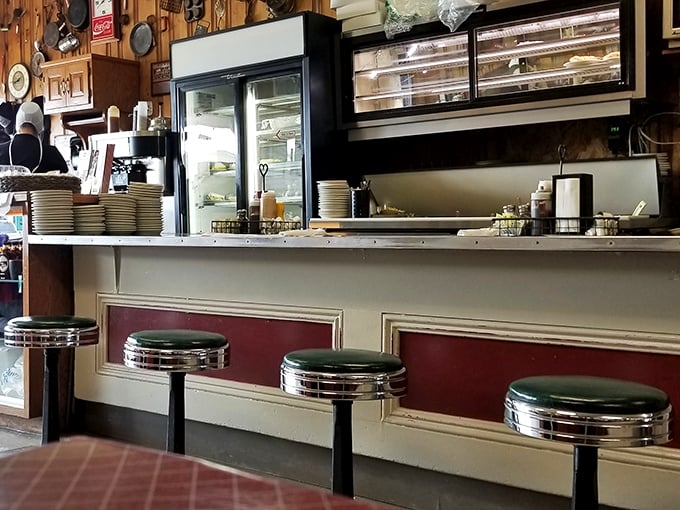Chrome stools lined up at the counter like soldiers ready for duty. This isn't just a place to eat&mdash;it's a front-row seat to culinary theater.