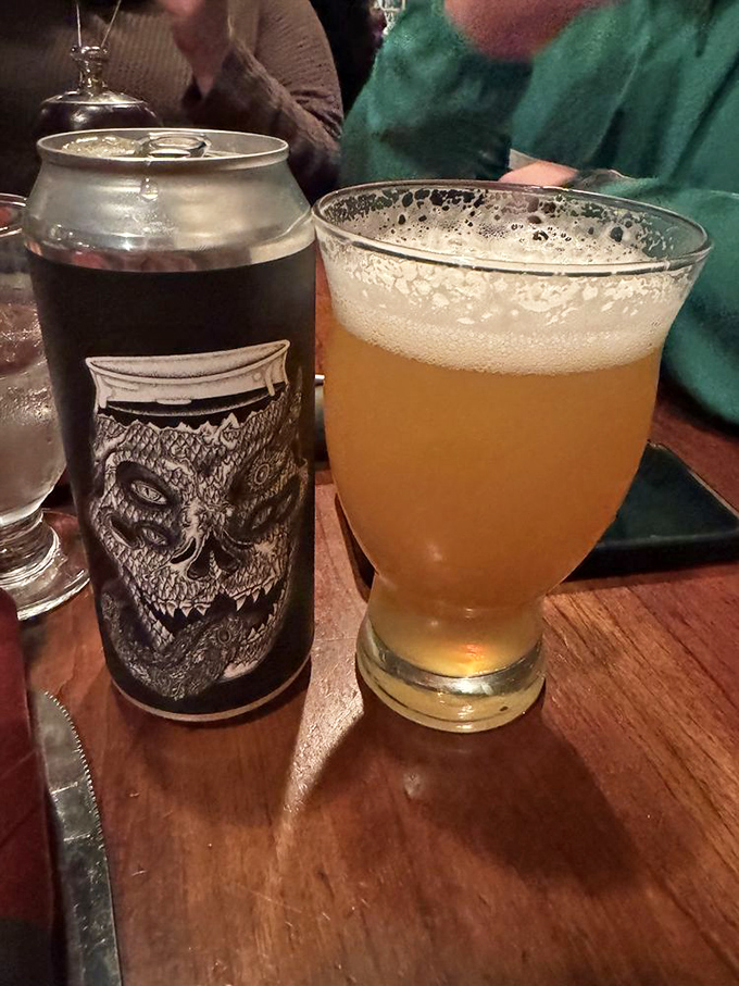 Beer served in proper glassware alongside craft cans—because even revolutionaries appreciate the correct vessel for their fermented rebellion.