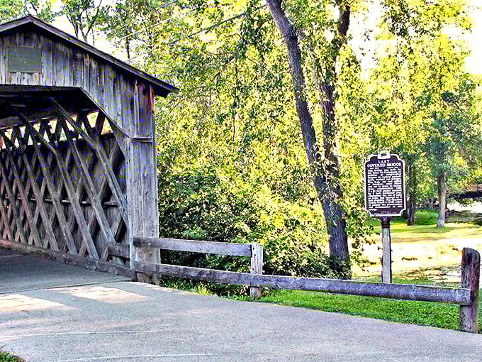 The covered bridge seems to whisper stories of horse-drawn carriages and simpler times. Its wooden lattice design creates patterns of light and shadow that photographers can't resist.