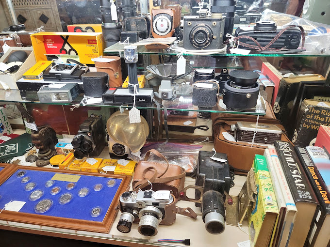 Cameras that captured history now make history themselves. Each viewfinder once framed someone's precious memories, now preserved behind glass.