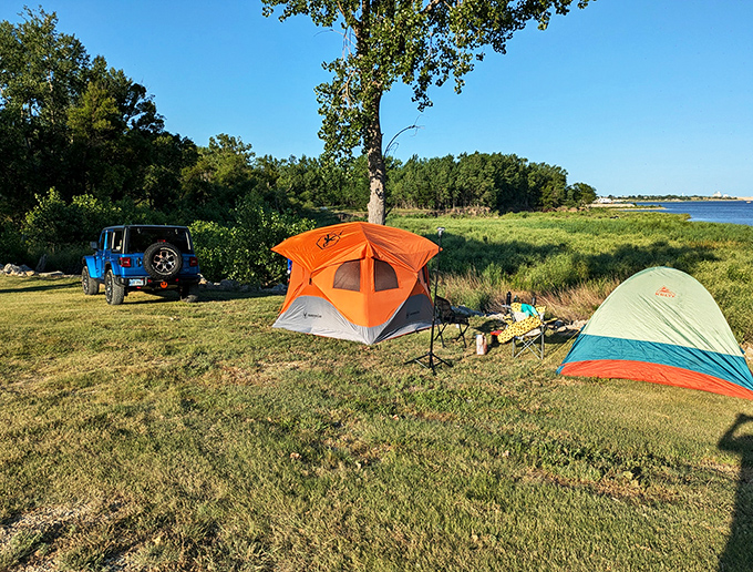 Home is where you pitch it. These colorful tents bring a touch of whimsy to the serene lakeside camping experience.