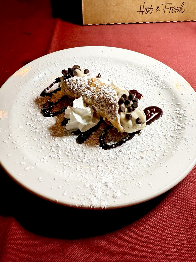 A cannoli that's dressed to impress with chocolate drizzle, powdered sugar, and a dollop of whipped cream. Sicily meets Colorado in sweet harmony.