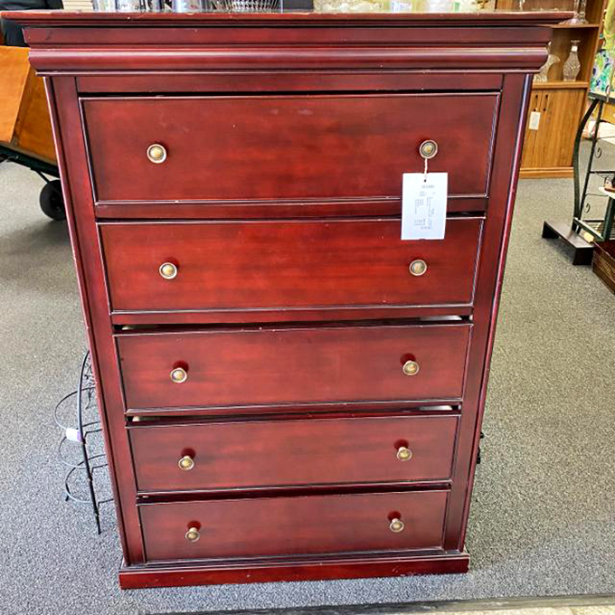 This handsome chest of drawers has the kind of rich, burgundy finish that makes you wonder what secrets its previous owners might have tucked away inside.