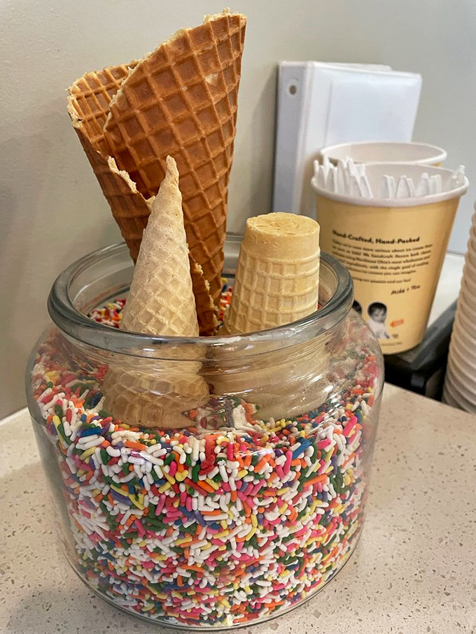Waffle cones standing at attention in their sprinkle battalion. The jar doubles as both storage solution and childhood dream visualization.