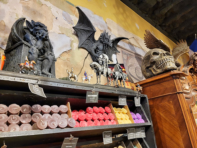 Gothic guardians watch over colorful candles&mdash;because nothing says "balanced home decor" like gargoyles supervising your aromatherapy collection.
