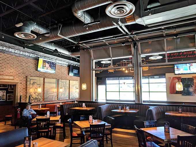 Industrial chic meets cozy comfort in this corner, where exposed ductwork somehow makes your conversation feel more authentic.
