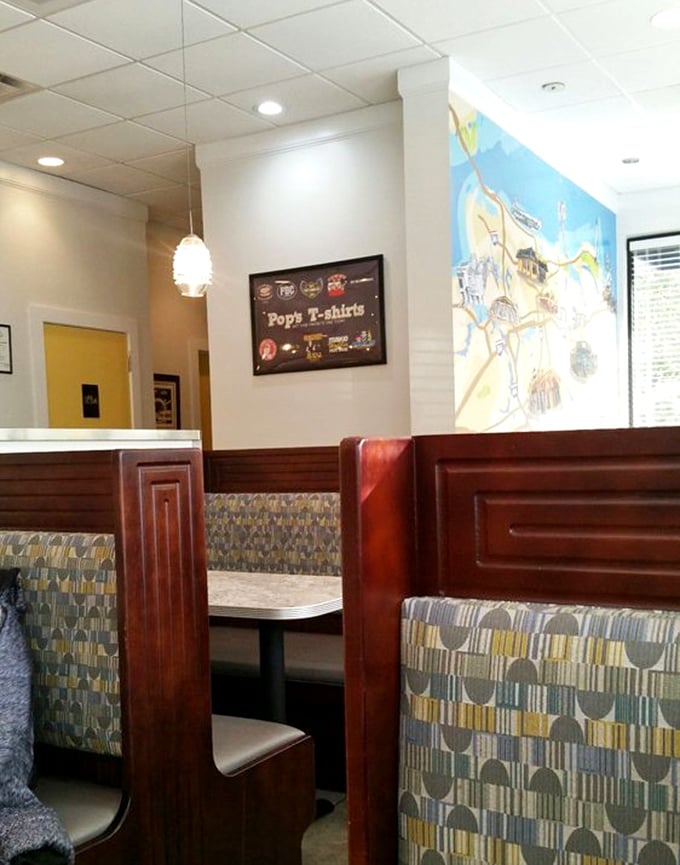 Classic diner booths: where comfort meets privacy. The mid-century pattern upholstery suggests your grandparents might have fallen in love in a booth just like this.