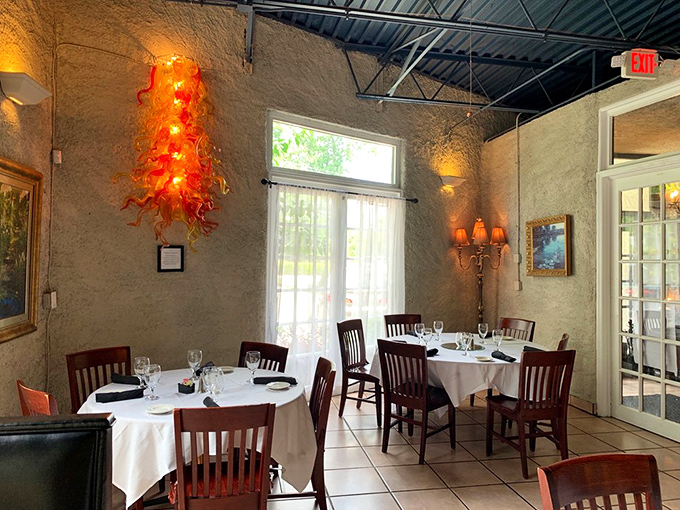 That stunning glass sculpture adds dramatic flair to a dining room already rich with ambiance. Dining here feels like being in on a wonderful secret.