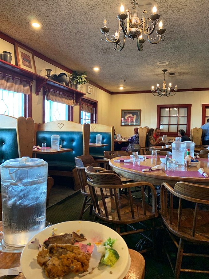 Country charm meets practical comfort in the dining room, where chandeliers cast a flattering glow over your third helping of mashed potatoes.