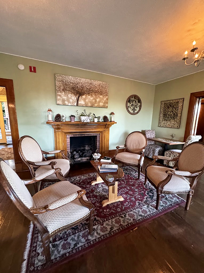 The parlor's intimate seating arrangement around the fireplace practically begs for whispered conversations and the occasional dramatic sigh. 