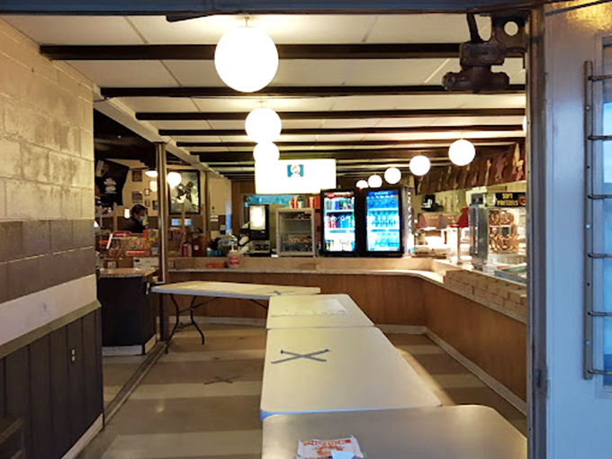 The concession stand interior&mdash;where wood paneling and globe lights create the perfect retro atmosphere for intermission socializing.