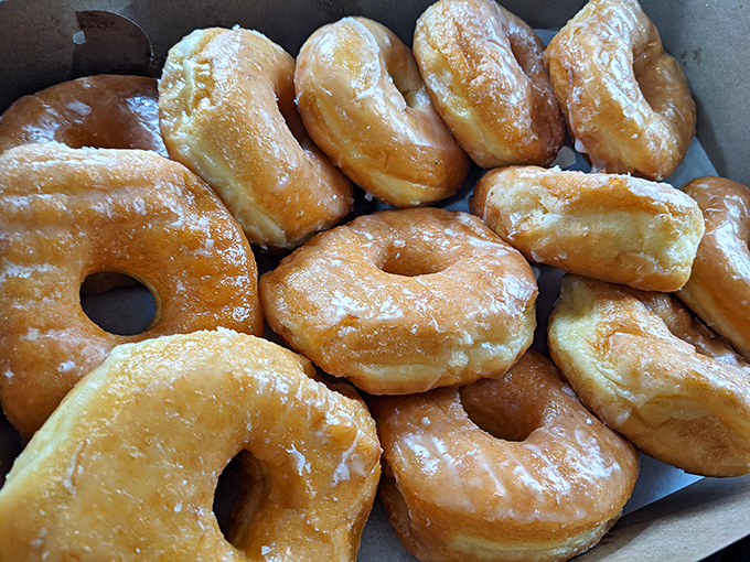 A dozen golden-glazed beauties, glistening with that signature sheen that whispers, "Yes, we're worth every calorie." Resistance is futile.