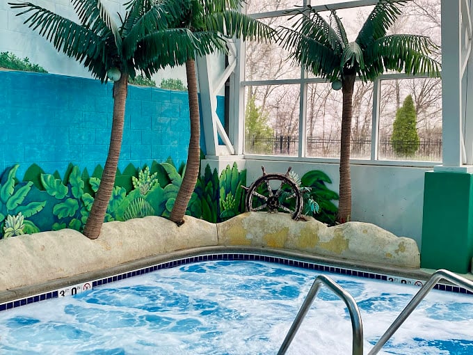 This hot tub oasis with faux palm trees is where adults retreat when they've had enough "family togetherness" for one hour. Parental sanctuary at its finest.