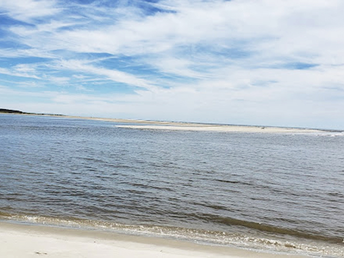 The tide's gentle retreat reveals a canvas of untouched sand, where each visit offers a fresh starting point.