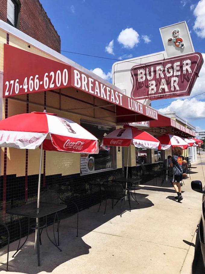 Sidewalk seating under Coca-Cola umbrellas&mdash;because vitamin D makes everything taste better. Summer in Bristol, served with a side of people-watching.