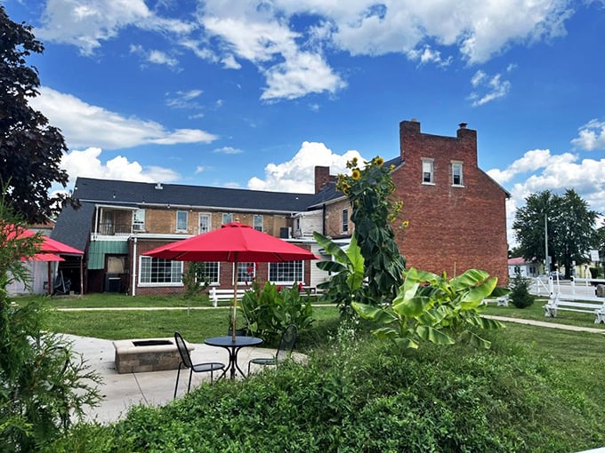 Summer at the Red Brick Tavern means dining under Ohio skies with a side of history. Those red umbrellas aren't just for shade—they're beacons for hungry travelers.
