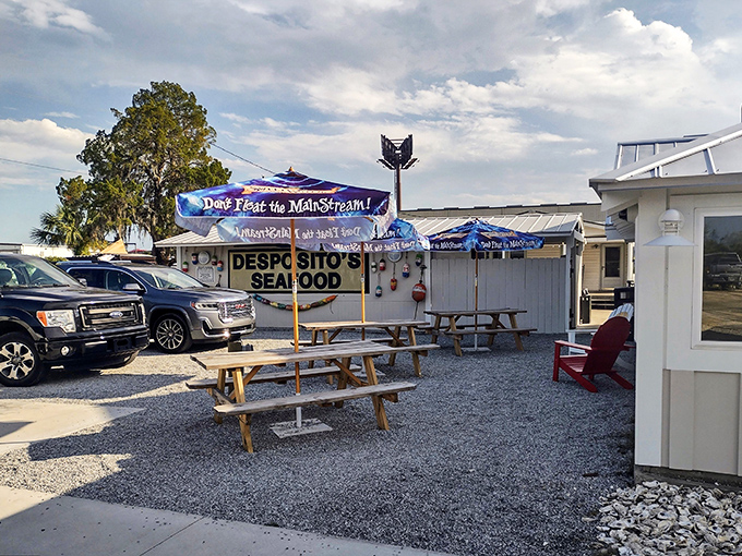 Outdoor seating complete with a "Don't Fear the MainStream!" banner&mdash;because nothing says authentic like a seafood joint with a sense of humor.