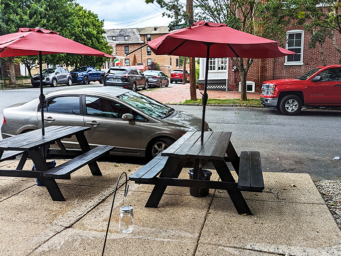 Outdoor seating under crimson umbrellas offers a front-row seat to Wilmington life passing by, with pasta paradise just steps away.