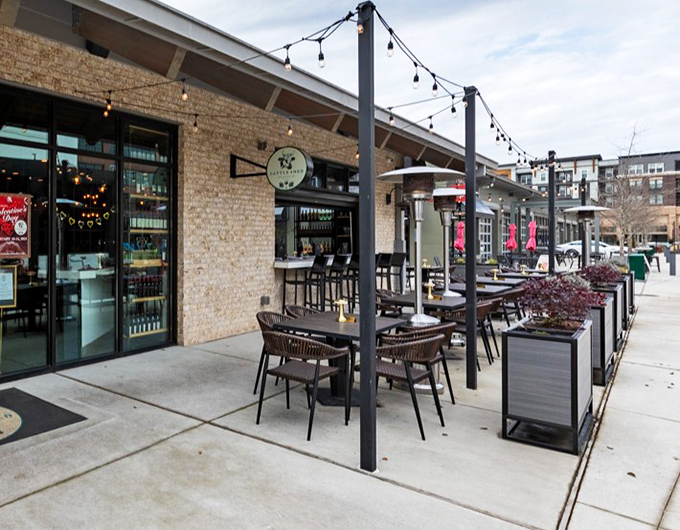 Al fresco dining with urban polish. These outdoor tables offer front-row seats to Alpharetta's evolving food scene, with overhead string lights setting the mood.