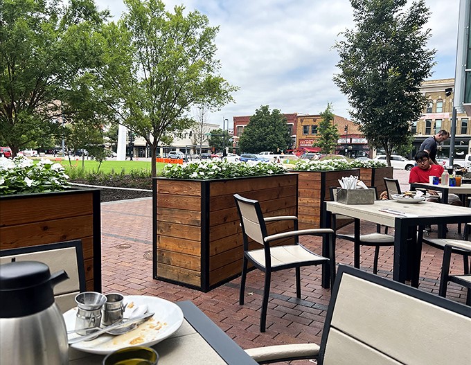 Outdoor dining that lets you enjoy your breakfast with a side of fresh air. These planters create natural privacy barriers between tables &ndash; breakfast diplomacy at its finest.