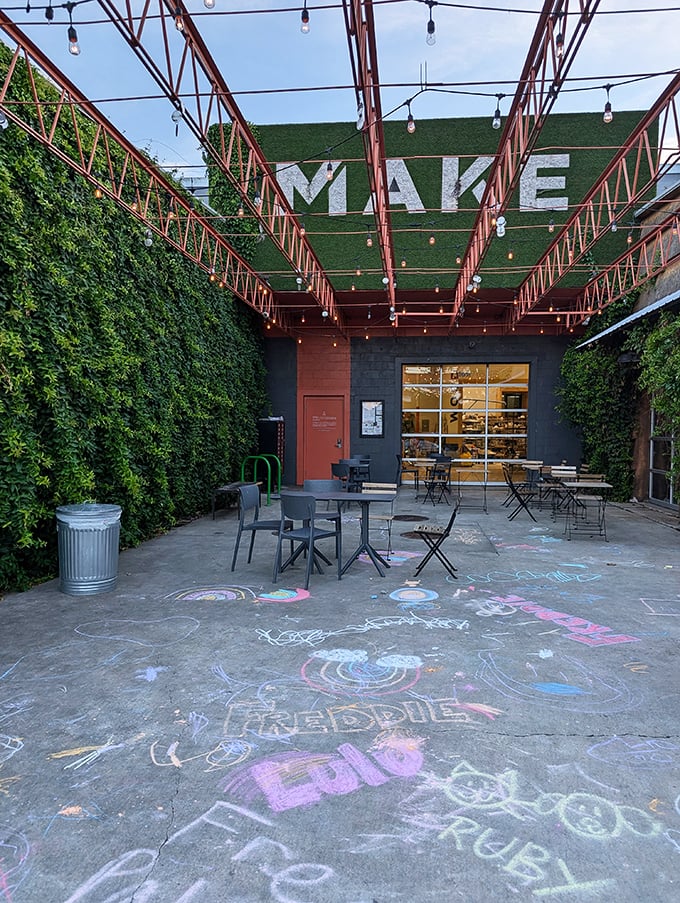 An outdoor oasis where string lights twinkle above and chalk art below reminds you that ice cream is serious business disguised as pure joy.