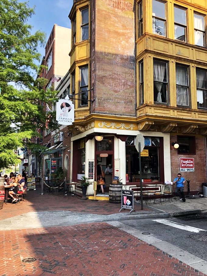 The bustling sidewalk scene isn't just people eating ice cream&mdash;it's a community united by the universal language of "mmmmm" on a sunny Philadelphia day. 