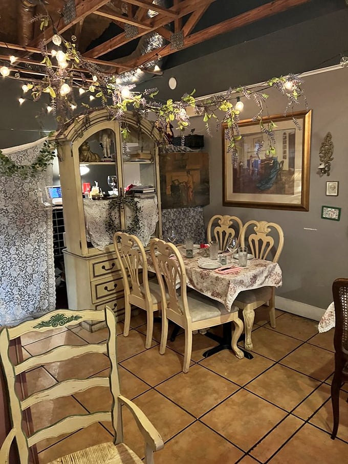 Cream-colored chairs, twinkling lights, and greenery hanging from wooden beams&mdash;dining rooms don't get more romantically French without requiring a passport.