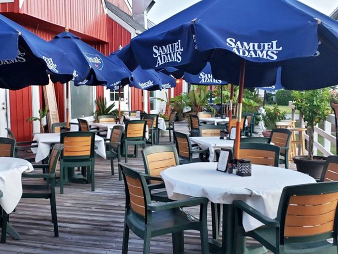 Samuel Adams umbrellas shade the outdoor patio, where sea breezes enhance every bite. Al fresco dining with a side of coastal charm.