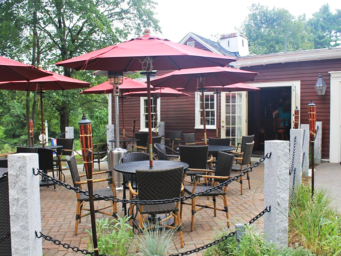 The outdoor patio, with its cheerful red umbrellas, transforms ordinary Tuesday dinners into mini-vacations without ever leaving Acton.