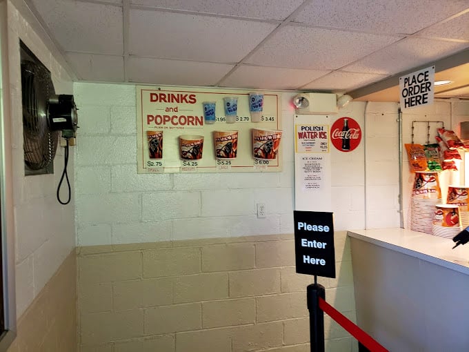 The concession counter's no-nonsense menu board promises the essentials&mdash;because some traditions, like movie popcorn, need no improvement. 