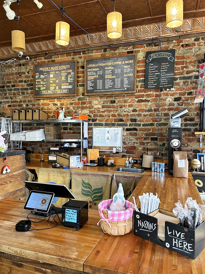 Where donut dreams come true. The counter area's exposed brick and warm lighting create the perfect backdrop for life-changing pastry decisions.