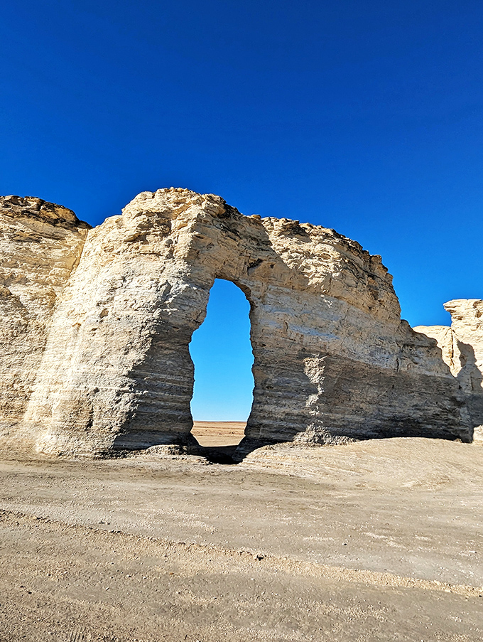 Nature's perfect archway frames the Kansas prairie beyond, a limestone doorway 85 million years in the making.