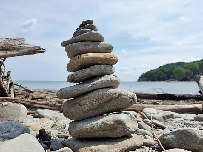 Someone's rock-stacking meditation created this lakeside sculpture—proof that the best art galleries sometimes have no walls at all.