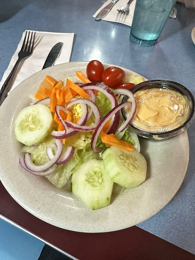 A garden-fresh side salad that's not trying to be the star, just the perfect supporting actor to your diner feast.