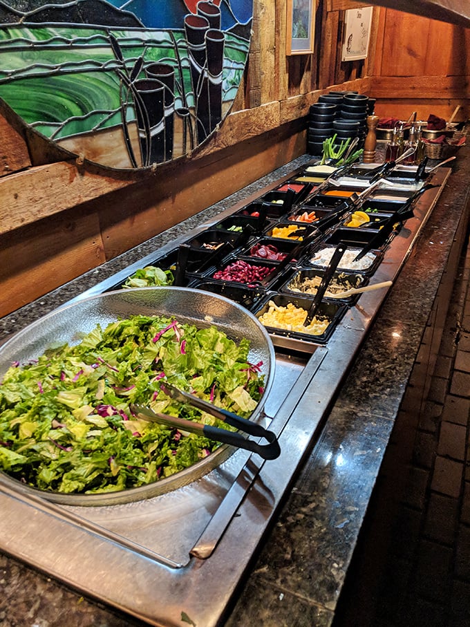 The salad bar &ndash; a rainbow of fresh ingredients where health-conscious decisions meet delicious possibilities. That stained glass adds a touch of church-like reverence.