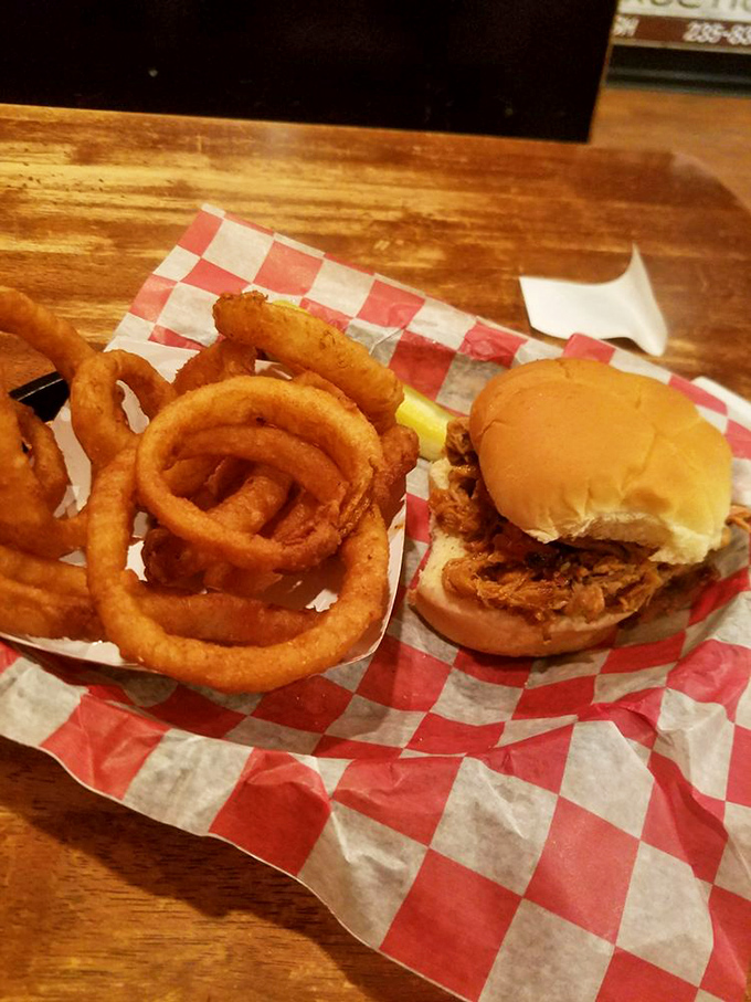 Onion rings large enough to double as bangle bracelets, paired with a sandwich that makes "just one more bite" the lie we tell ourselves.