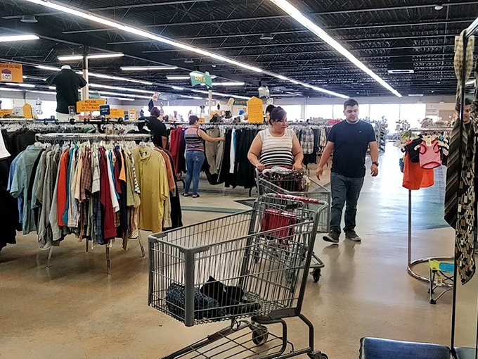 Real-life treasure hunters navigate the clothing forest with laser focus, their shopping carts poised for the next great discovery.