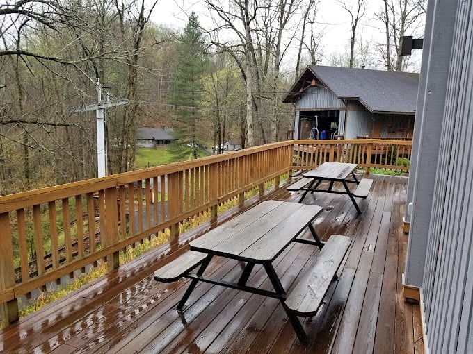 Rain-slicked picnic tables wait patiently for sunshine and families, proof that simple pleasures still outrank digital distractions.