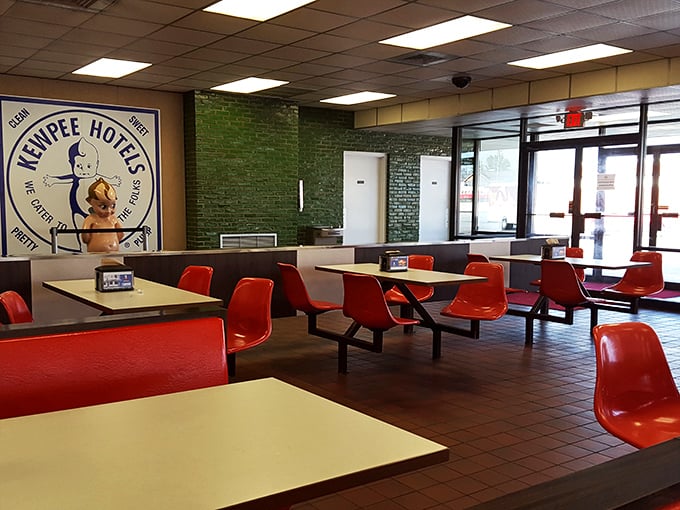 The iconic Kewpee doll watches over diners from the wall&mdash;a quirky guardian angel of good eating in a sea of red chairs.